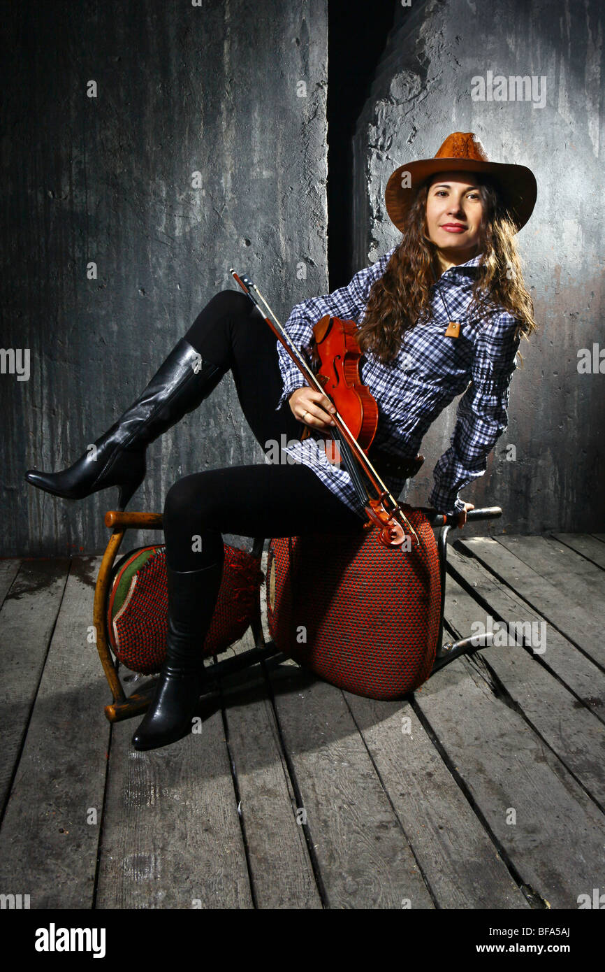 Beautiful violinist country performer on grey wall background Stock ...
