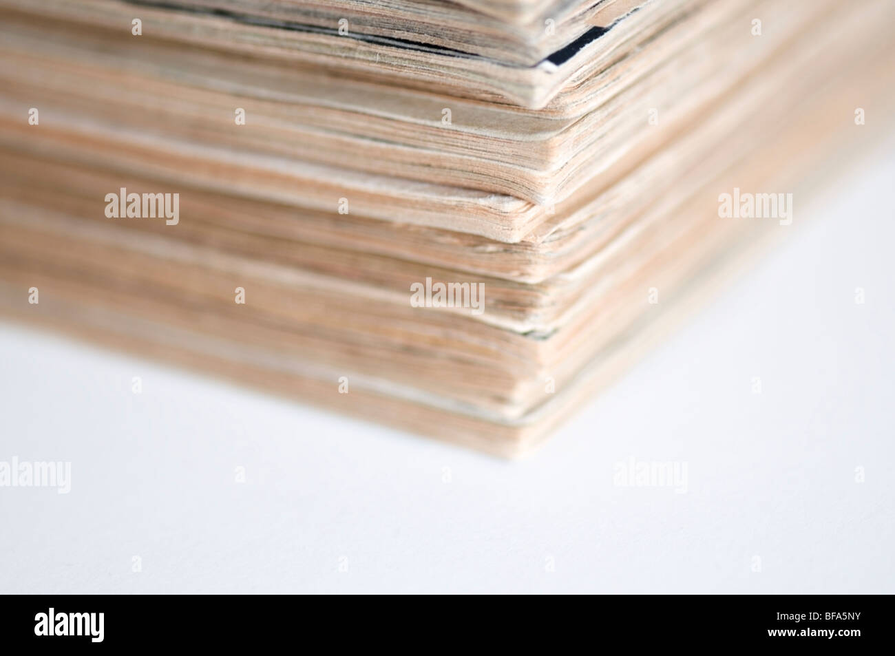 Corner view of piled old, aged, 1960s yellowing magazines copies on ...