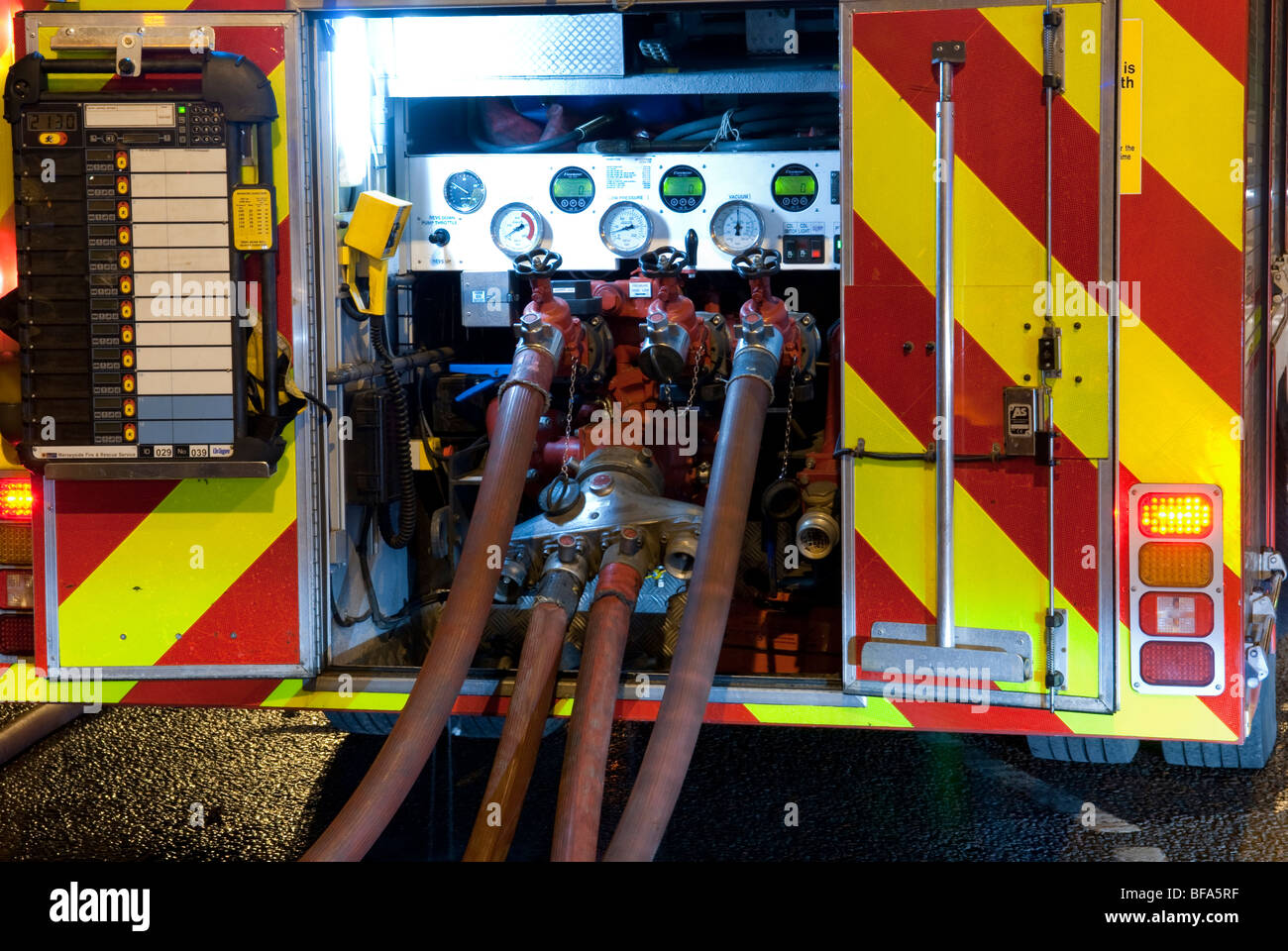 Rear locker and hose of fire engine at night Stock Photo - Alamy