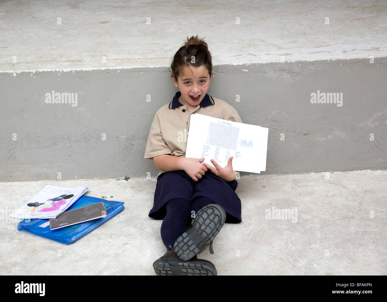 Schoolgirl holding homework Stock Photo - Alamy