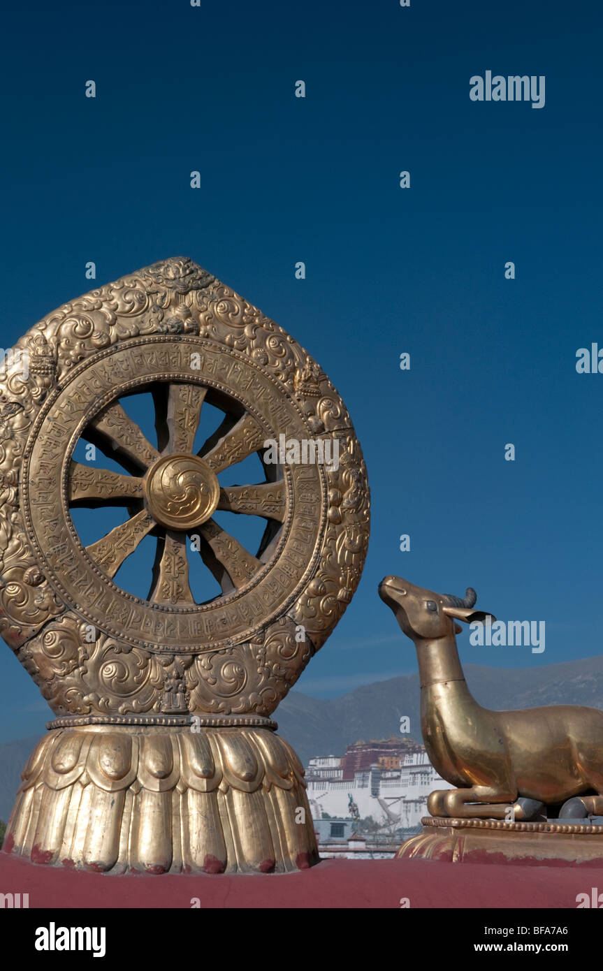 Two deer sit on either side of the wheel of dharma on the roof of the ...