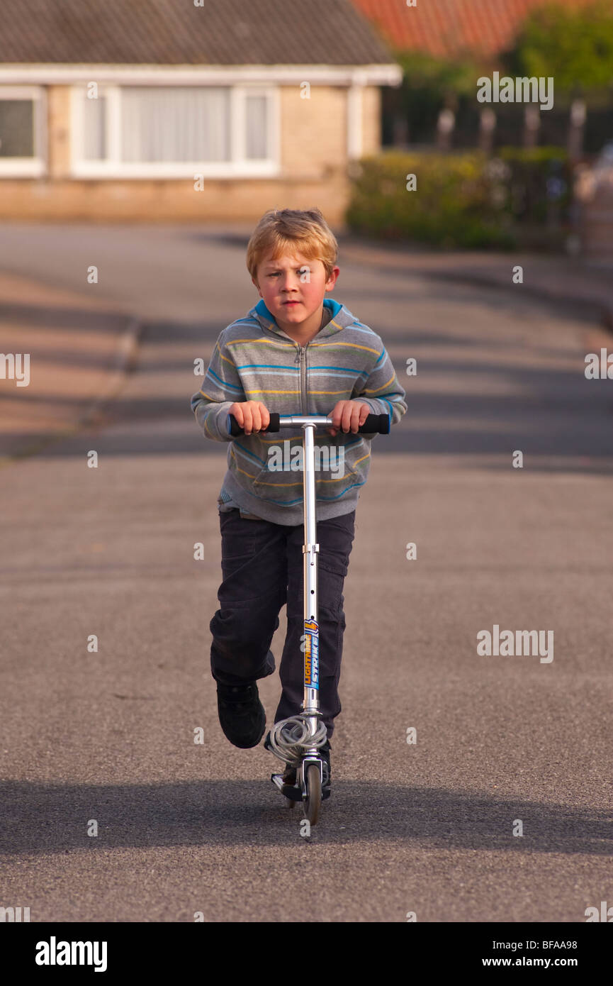 A Model Released picture of a six year old boy scooting on his scooter ...