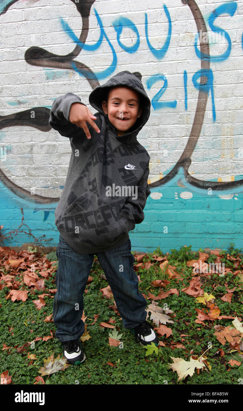 Young boy giving attitude by graffiti wall Stock Photo - Alamy