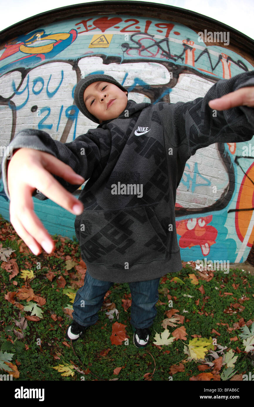 Young boy giving attitude by graffiti wall Stock Photo - Alamy