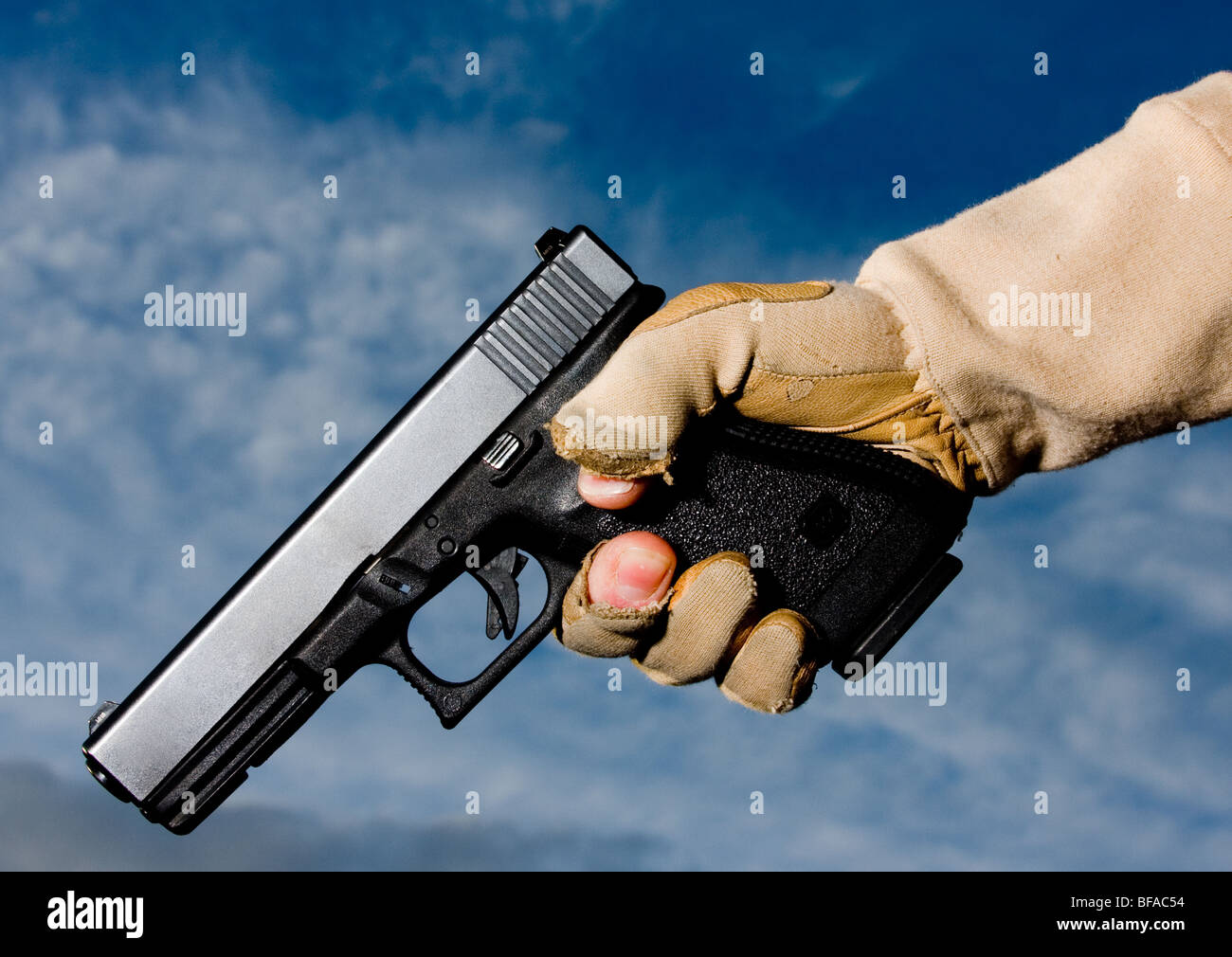 Handgun with sky background Stock Photo - Alamy