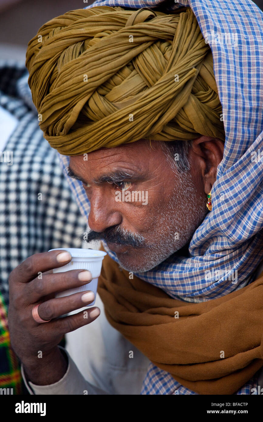 Rajput man drinking chai at the Camel Fair in Pushkar India Stock Photo ...