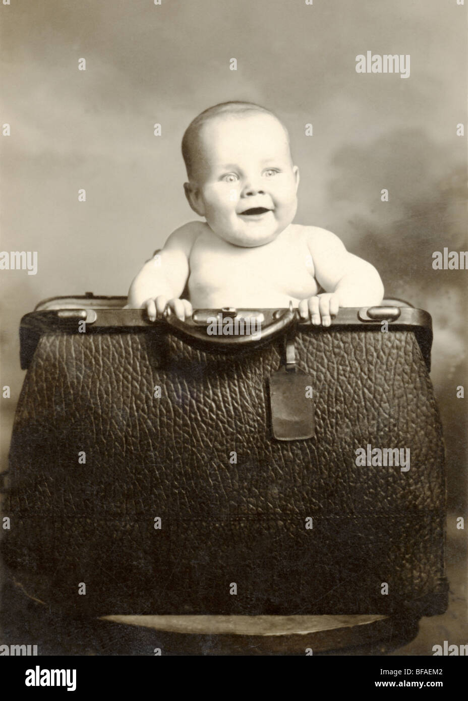 Baby Popping Out of a Traveling Bag Stock Photo - Alamy