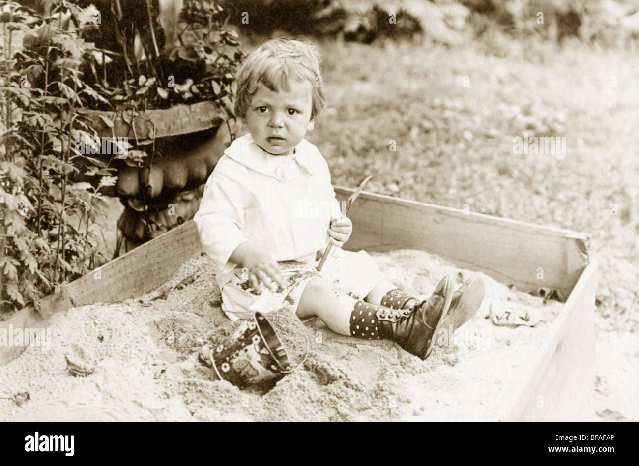 Sad Little Boy in Sandbox Stock Photo - Alamy