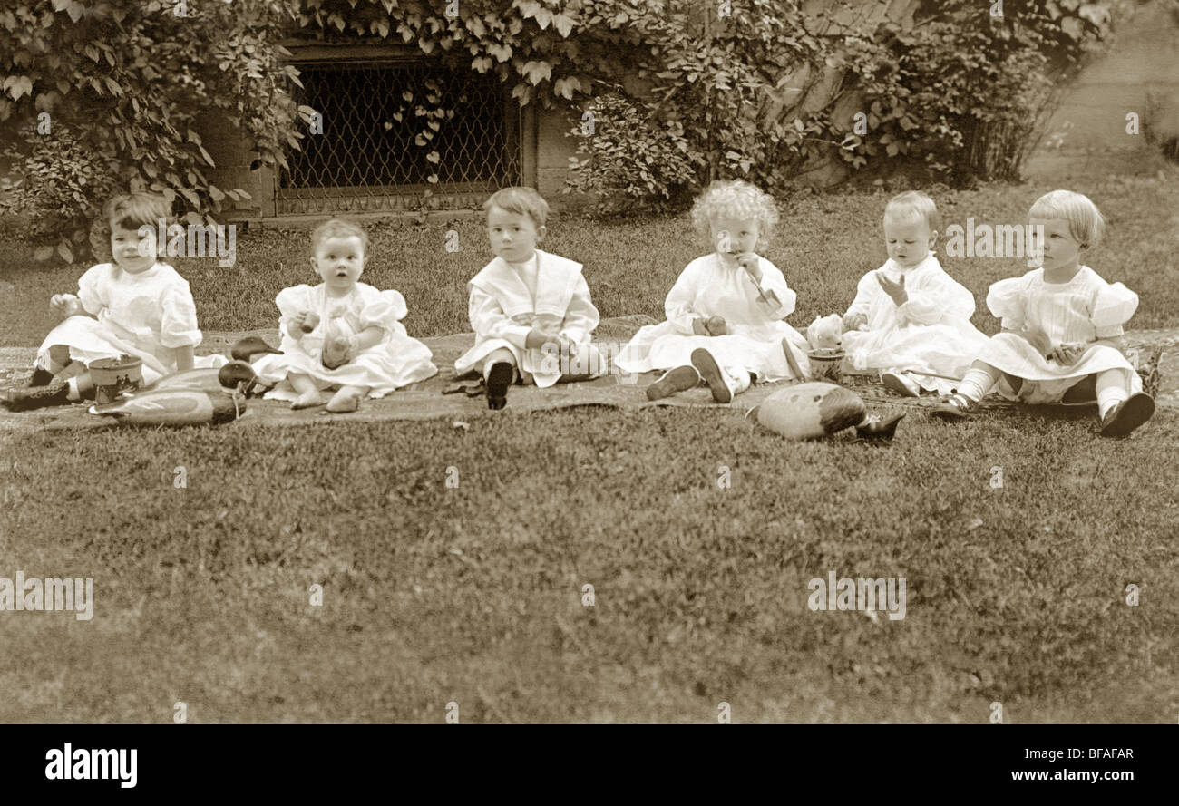 Six Little Children Playing on the Lawn Stock Photo - Alamy