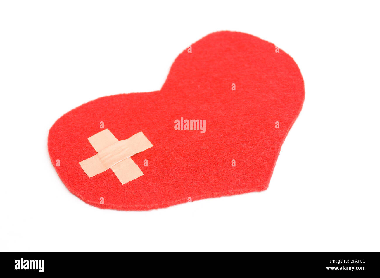 Sticking plasters or band-aide on a heart to illustrate broken heart or ...