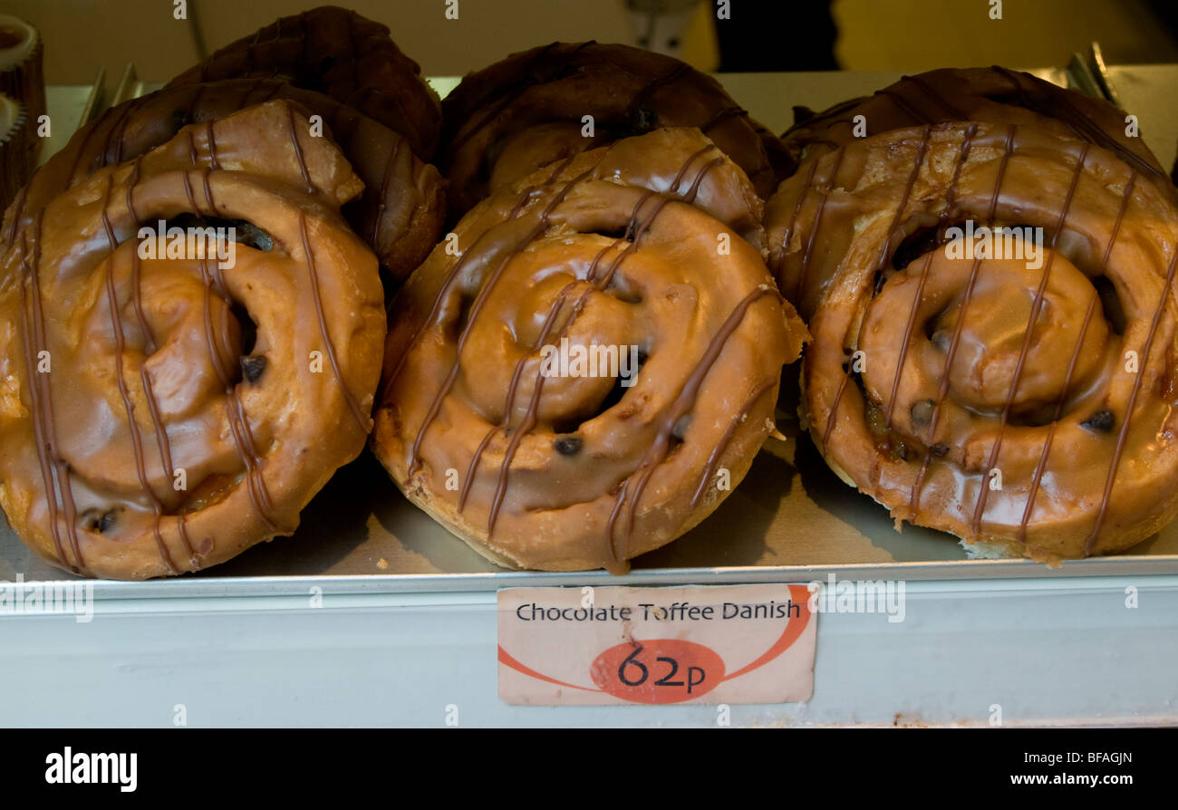 Buns and cakes on display in a shop window York city center England ...