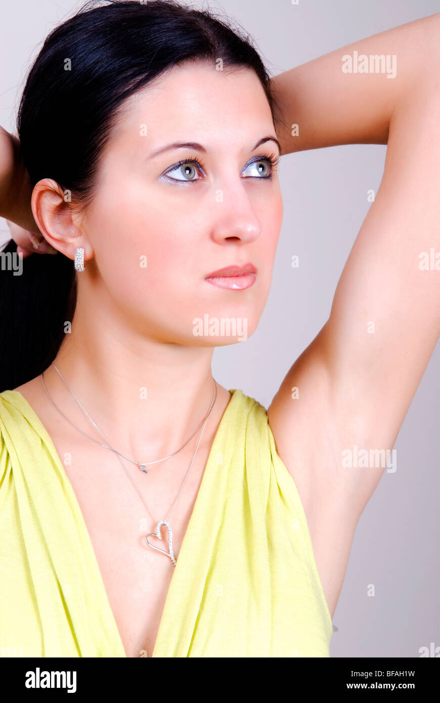 Beautiful young woman arms behind her head Stock Photo - Alamy