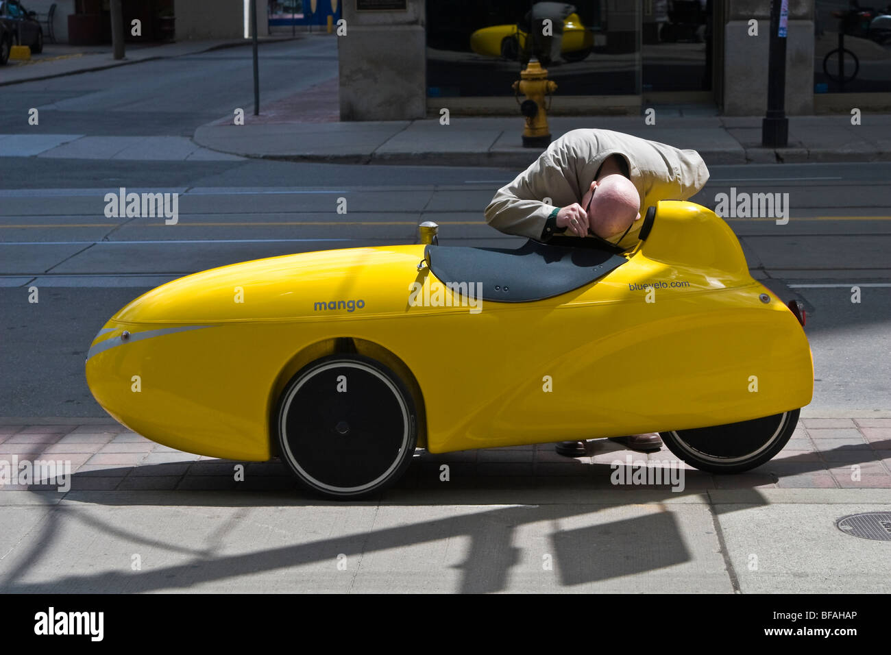 Yellow velomobile, Mango model, seen in the streets of Toronto Stock ...
