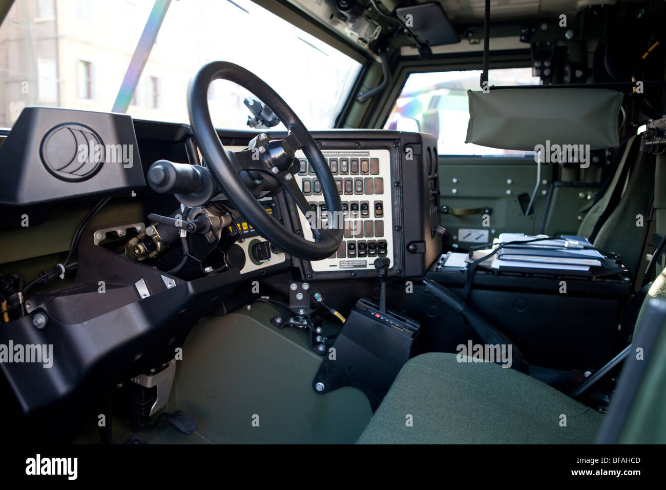 Detail of a military jeep inside: steering wheel and army command ...