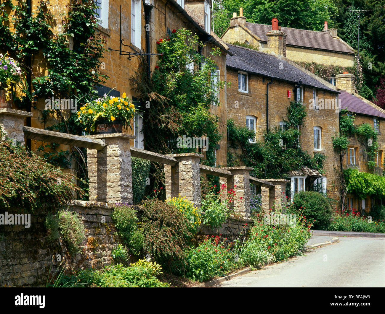 The main street in the beautiful cotswold village of Blockley with its ...