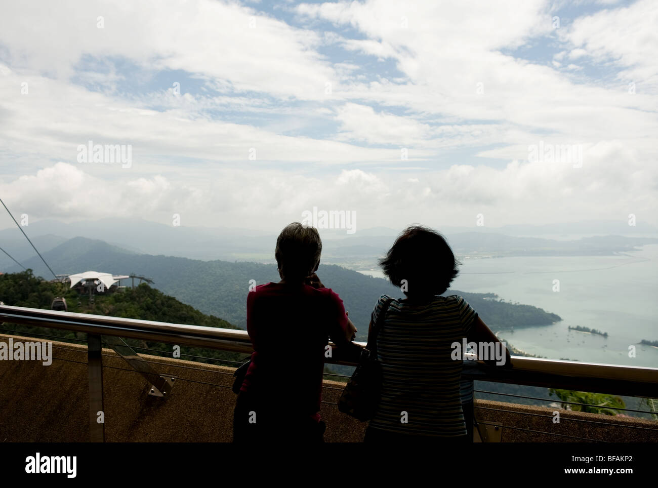 Two tourists on top of Gunung Mat Chinchang looking out at the ...