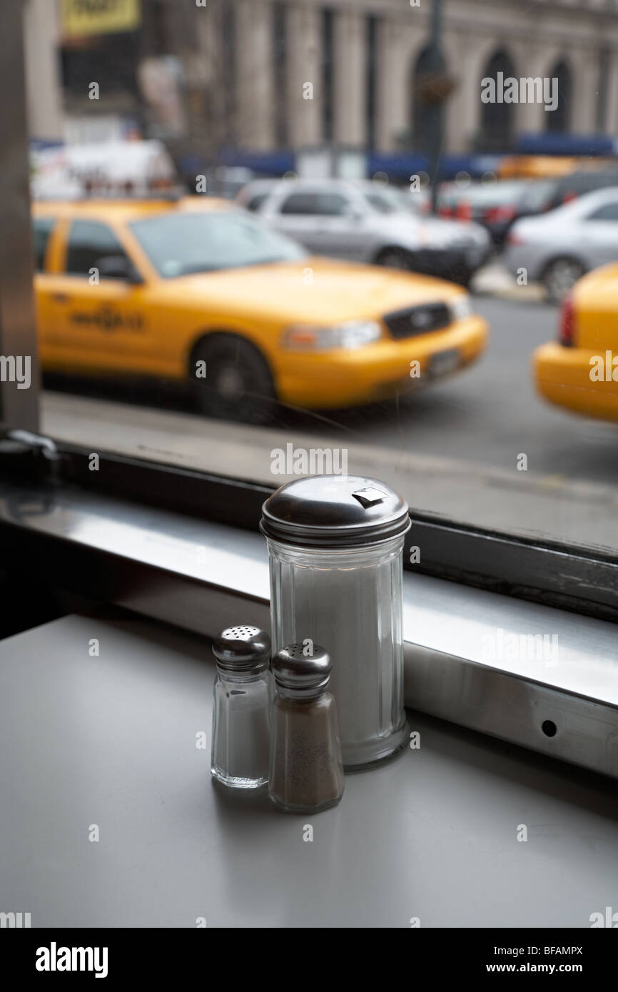 View out of a diner window with parked taxis outside Stock Photo - Alamy
