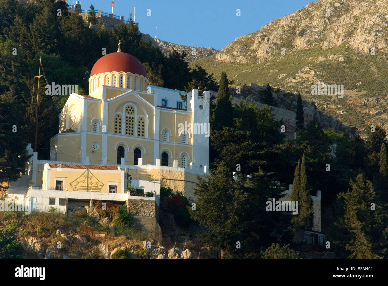 Greek Church on the hillside overlooking Simi Harbour, Island of Simi ...