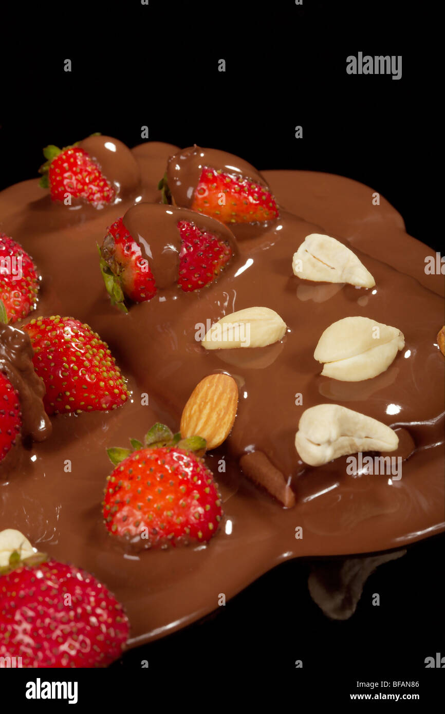 Ripe strawberry in dairy chocolate on a black background Stock Photo ...