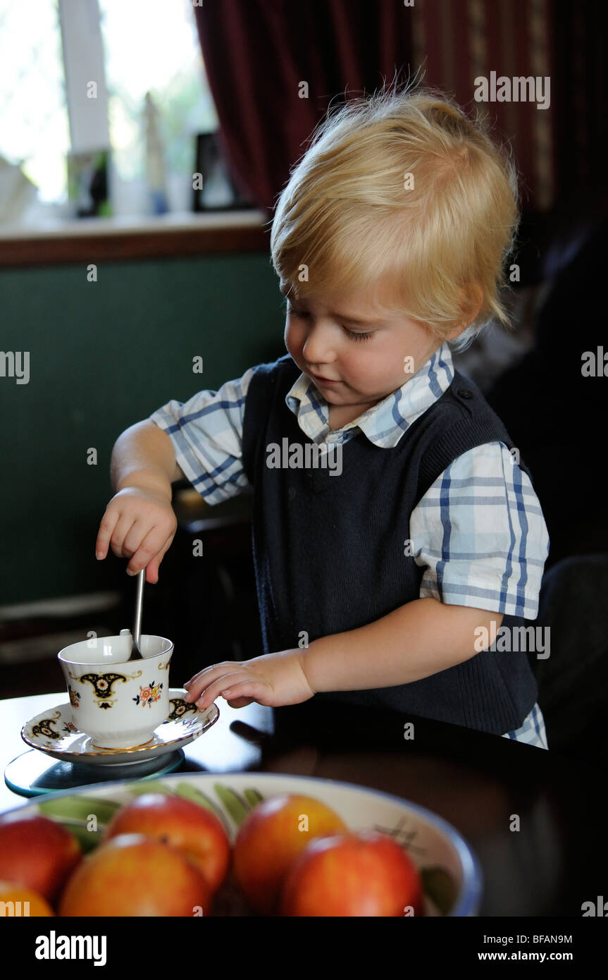 Young boy making tea hi-res stock photography and images - Alamy