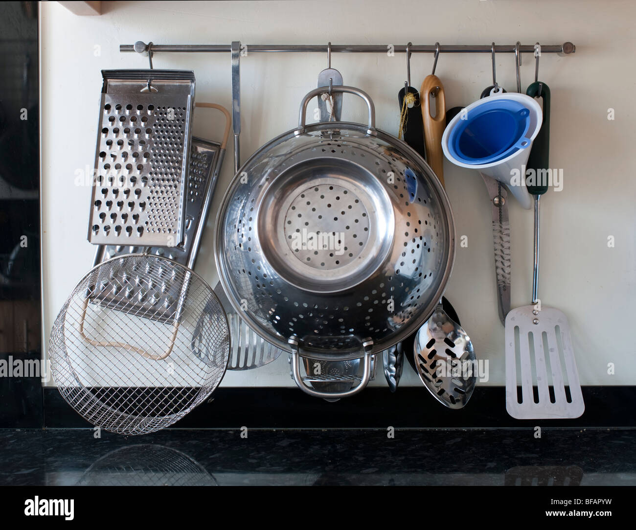 kitchen tools and implements on wall rack Stock Photo - Alamy