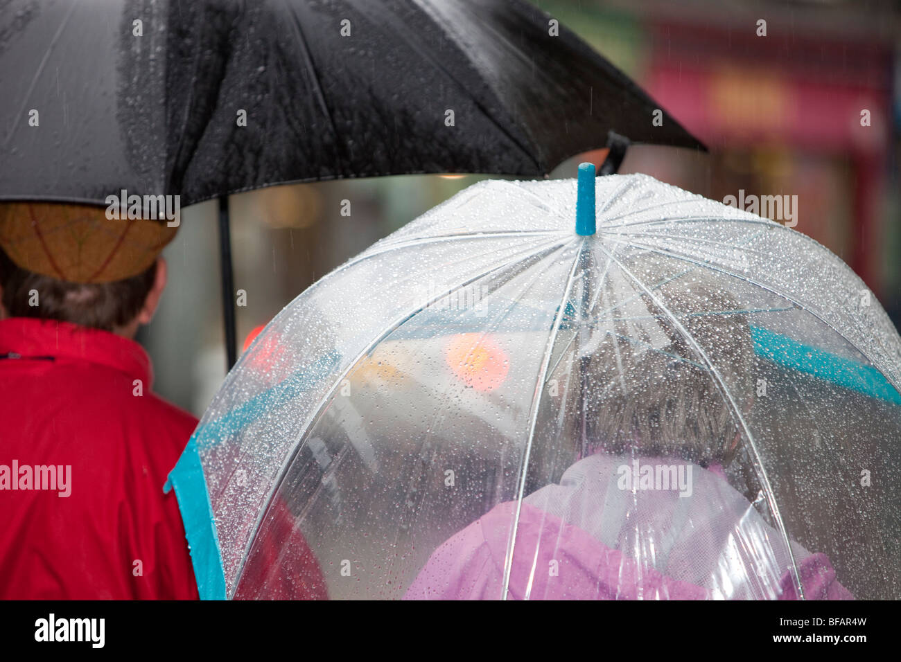 People using umbrella's in the rain in Ambleside, Cumbria, UK Stock ...