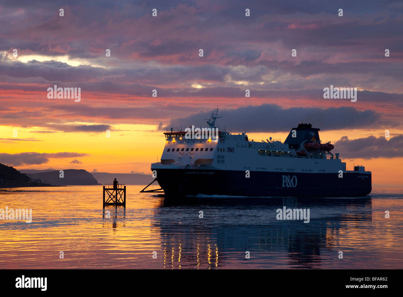Passenger ferry entering Larne Harbour at sunset Stock Photo - Alamy