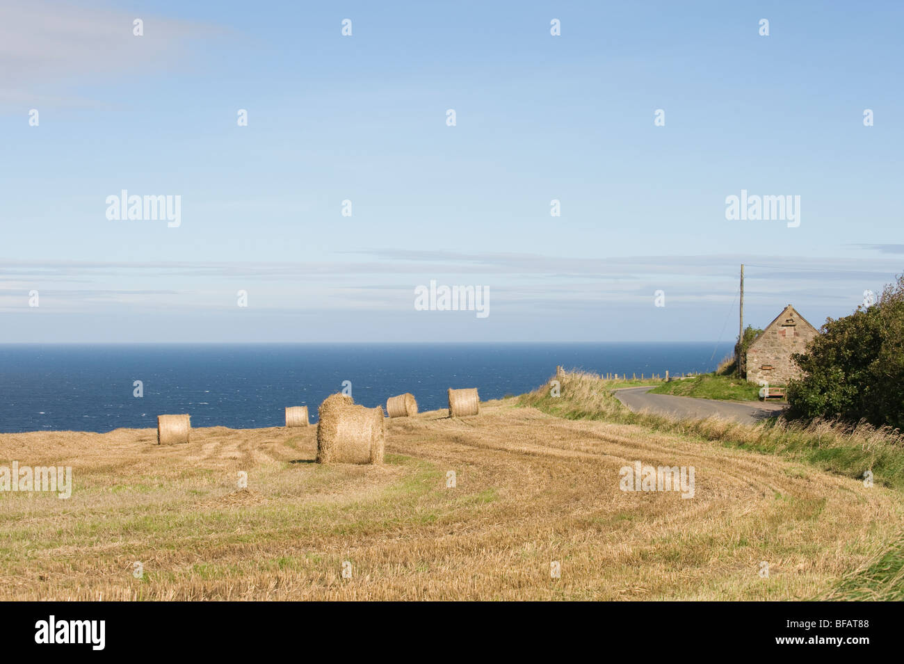 Baling straw after cereal harvest. Above Gardenstown, Scotland, UK ...