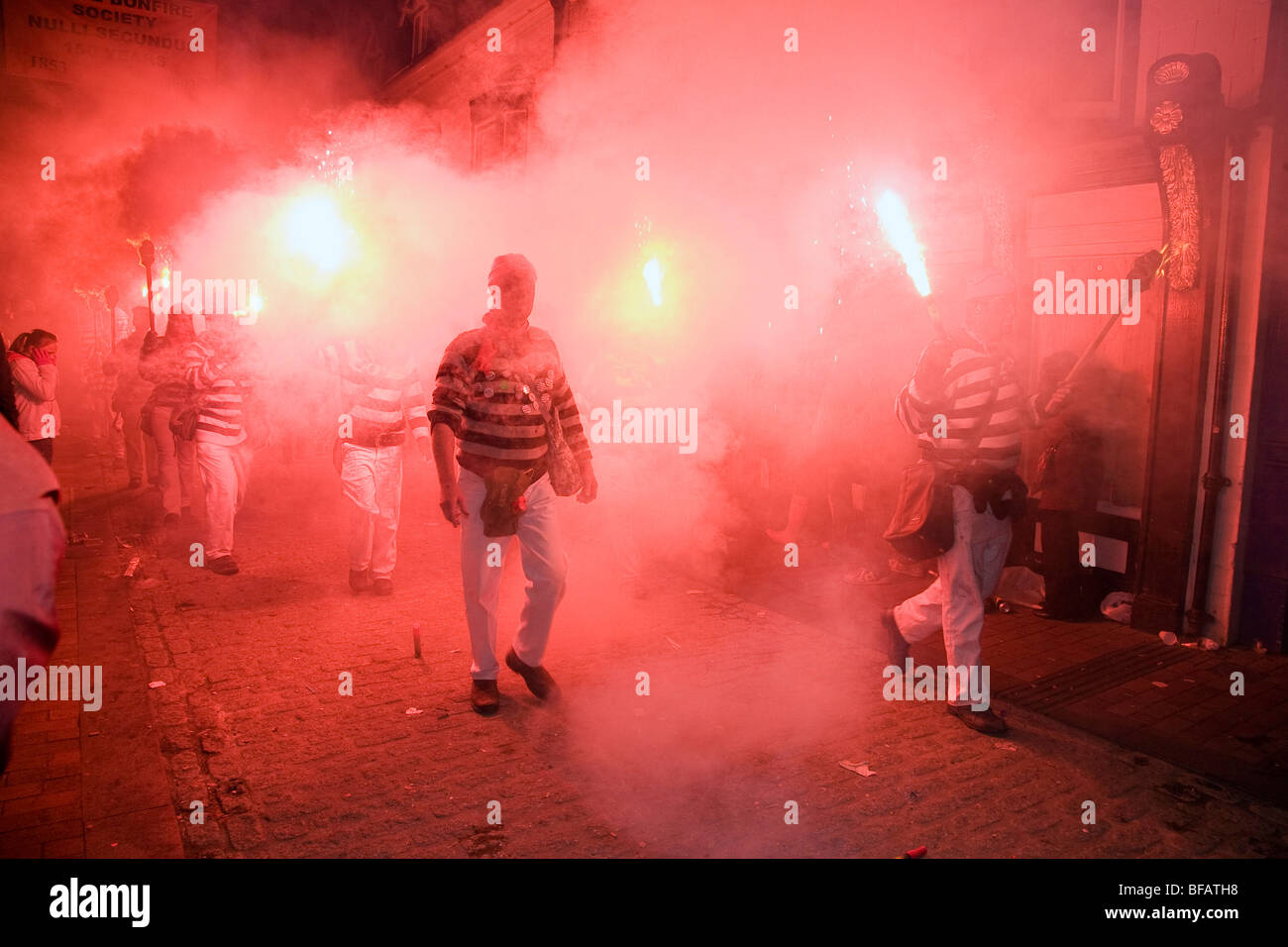 Lewes bonfire night procession. Flares, smoke and torches create ...