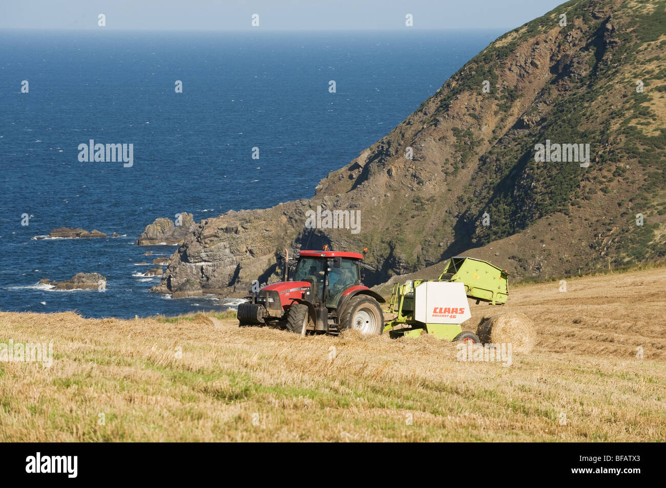 Baling straw after cereal harvest. Above Gardenstown, Scotland, UK ...