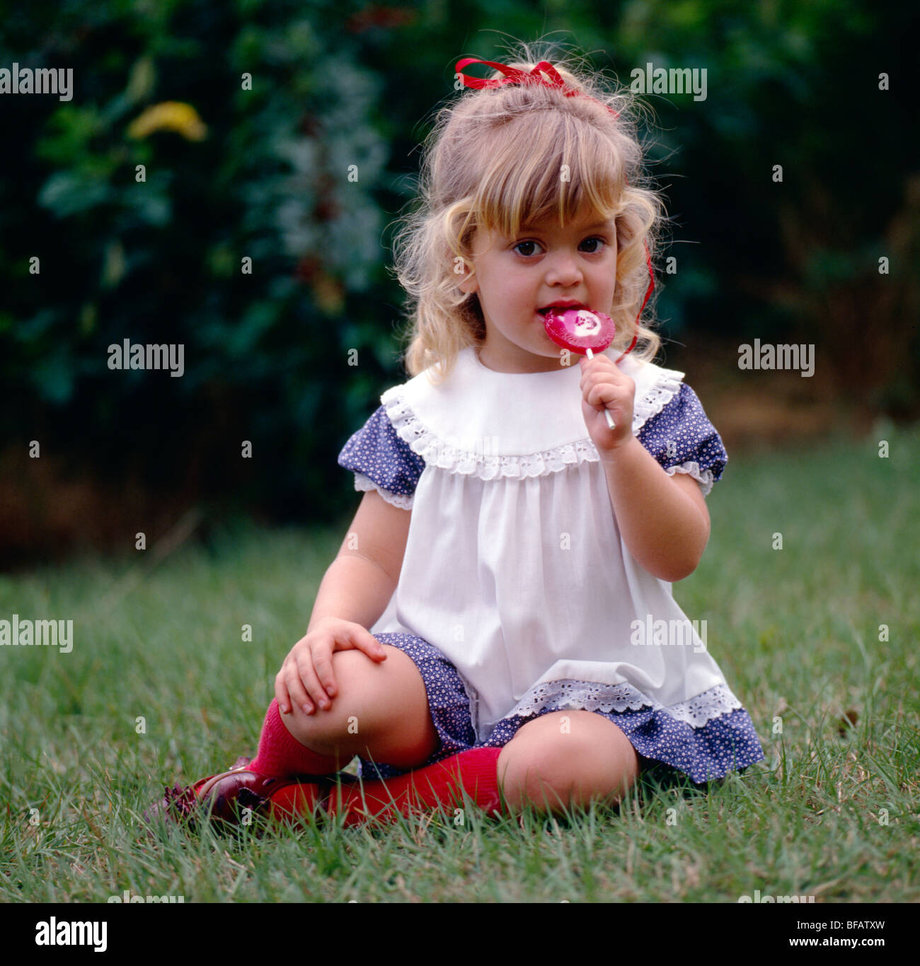 Young girl with candy sucker Stock Photo - Alamy