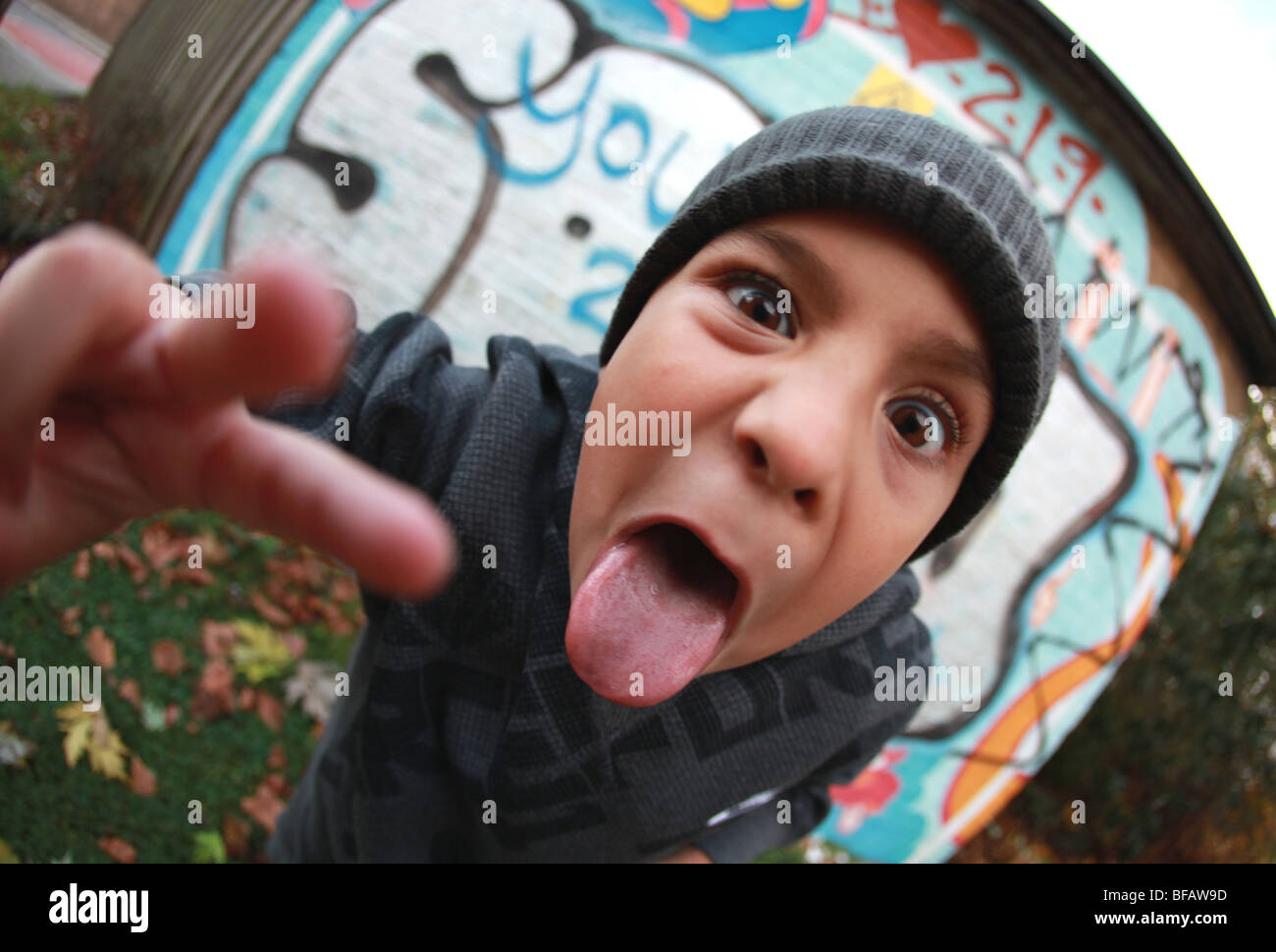 Young boy giving attitude by graffiti wall Stock Photo - Alamy