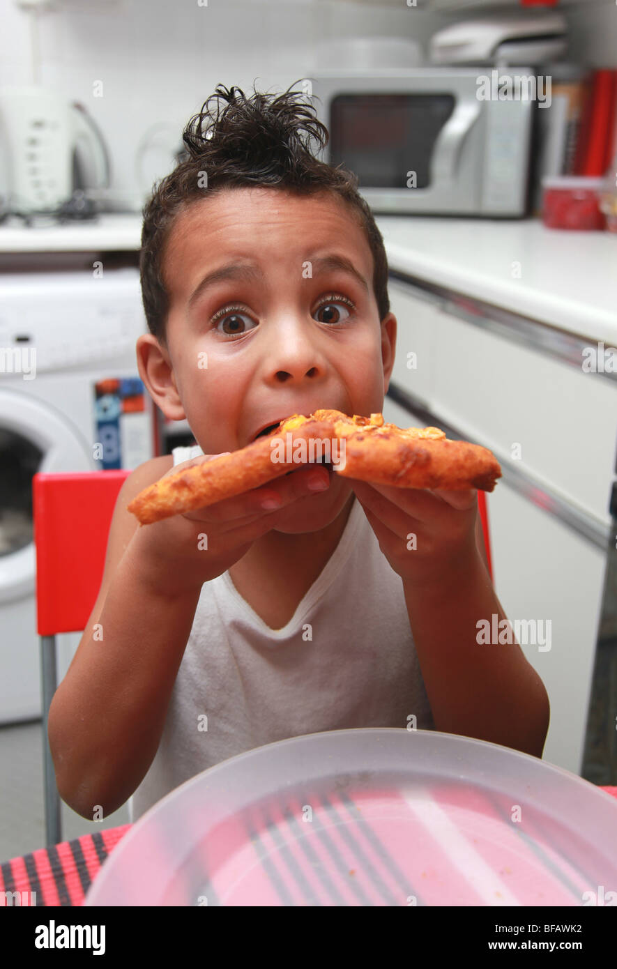 Year old boy eating pizza hi-res stock photography and images - Alamy