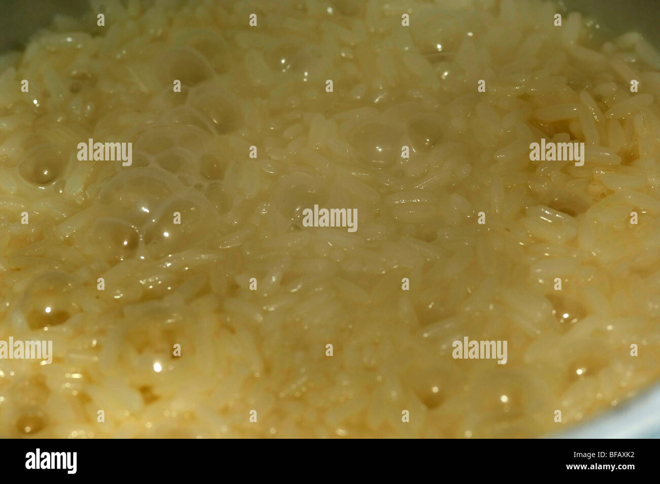 Rice cooker kitchen- Close up of rice and boiling water Stock Photo - Alamy