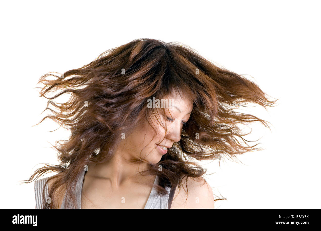 Portrait of a smiling female with fluttering hair Stock Photo - Alamy