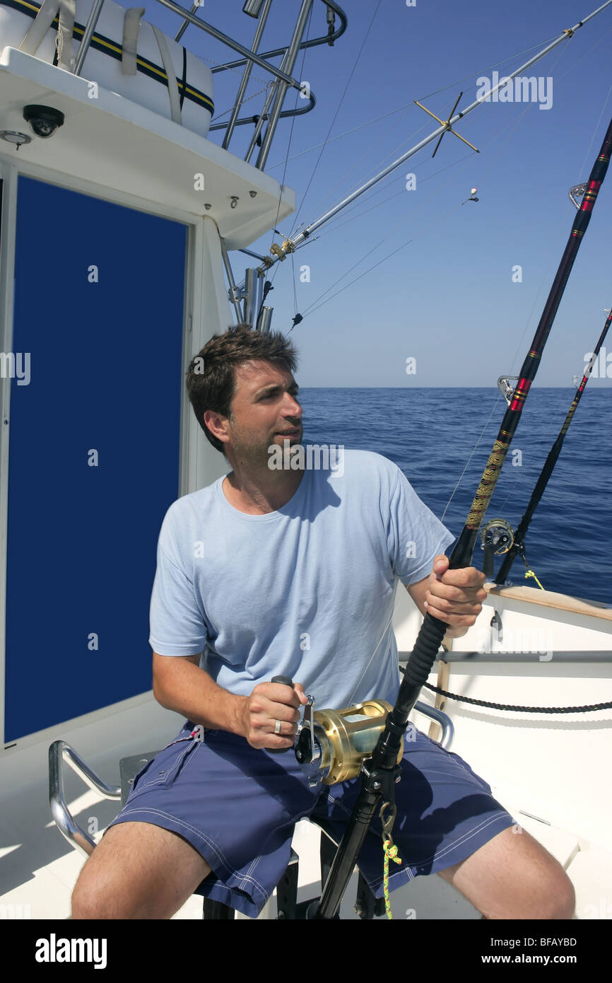 Angler big game saltwater fisher boat with rods and reels Stock Photo ...
