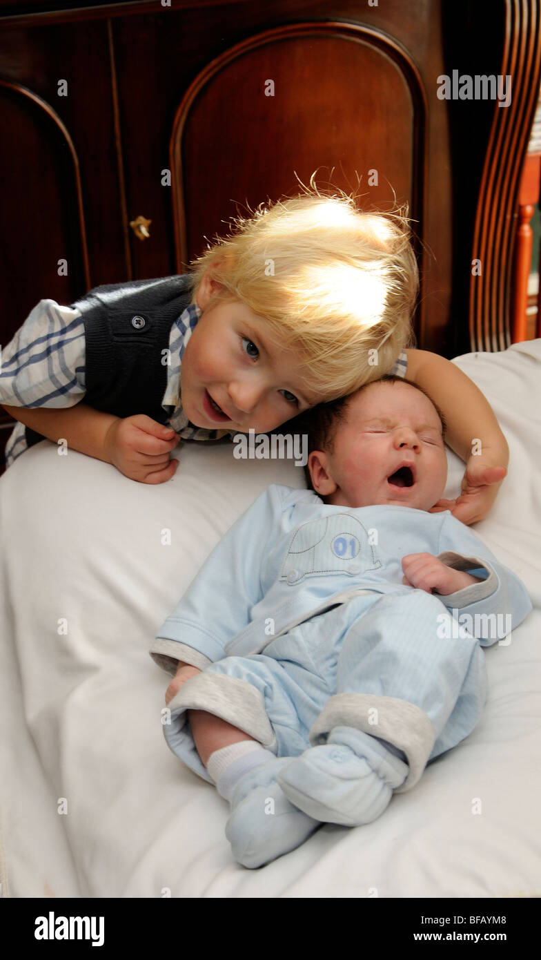 Portrait of a young boy and baby brother Stock Photo - Alamy