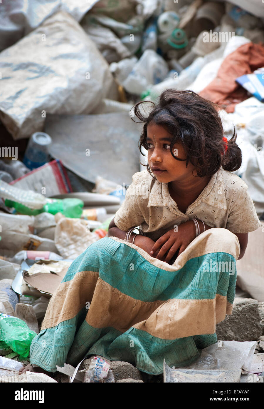Young Indian Lower Caste Street Girl Sitting Amongst Rubbish Dump That