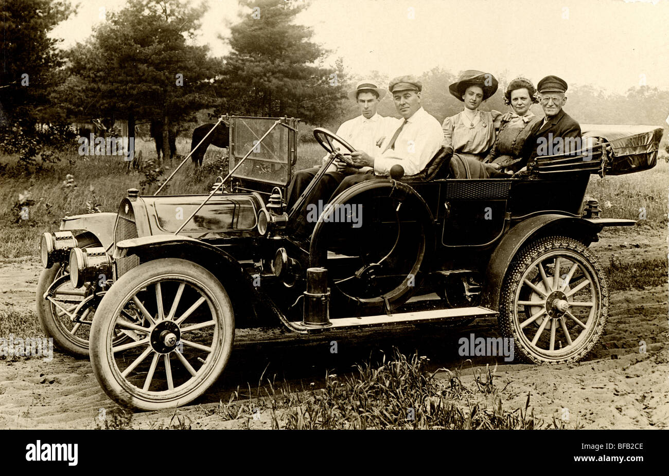 Five People Riding in Old Touring Car Stock Photo - Alamy
