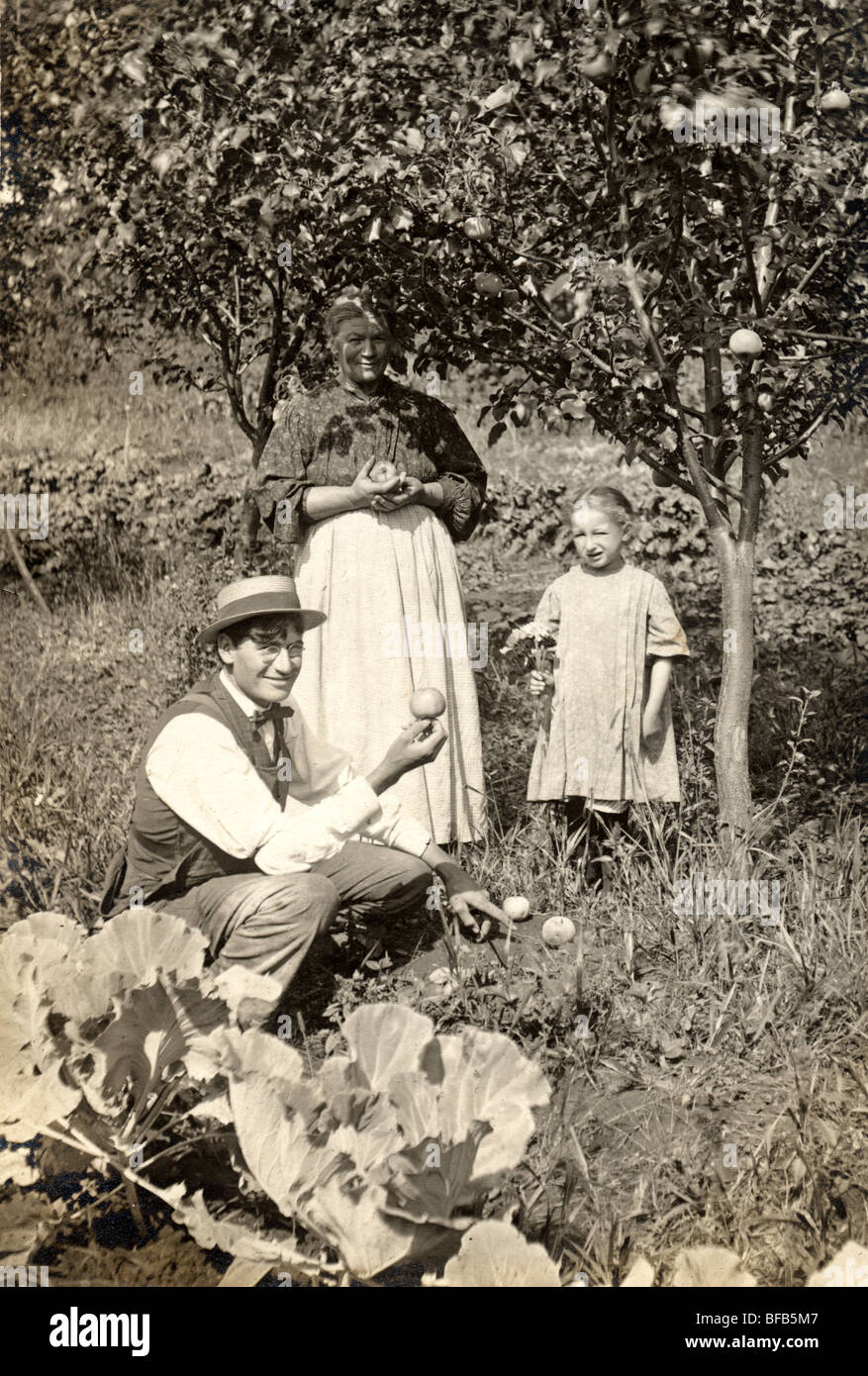 Farm Family Displaying Apples in Orchard Stock Photo - Alamy