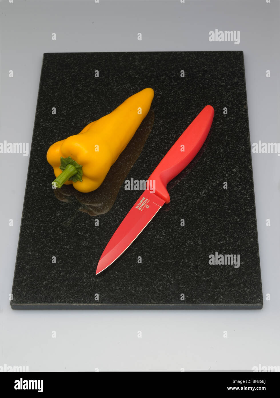 Red Paring Knife and Yellow Romano Pepper Stock Photo - Alamy