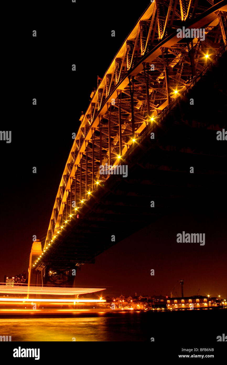 Boat going under the Sydney Harbour Bridge, NSW, Australia Stock Photo ...