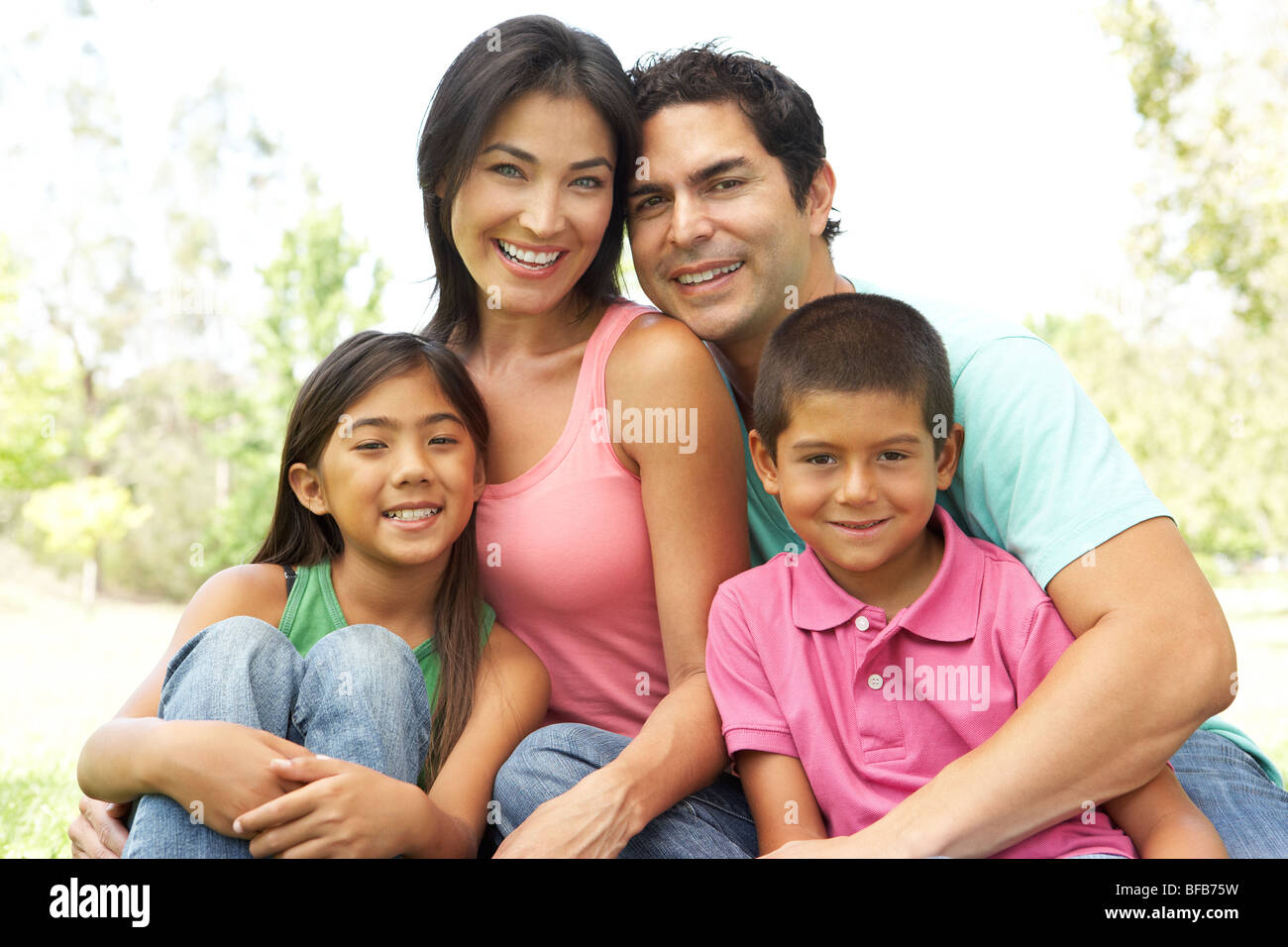 Portrait Of Young Family In Park Stock Photo - Alamy
