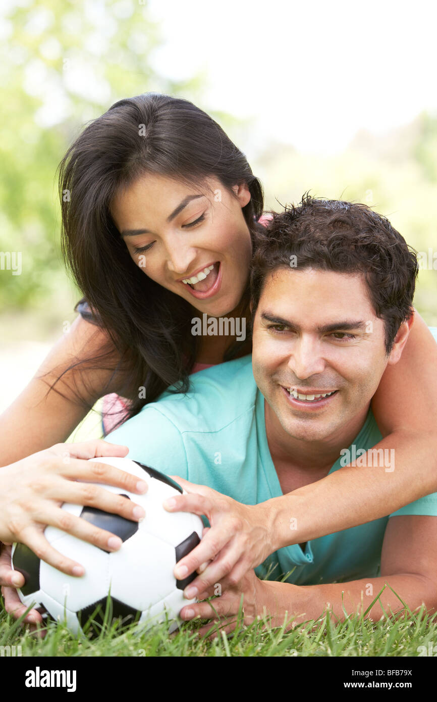Couple In Park With Football Stock Photo - Alamy