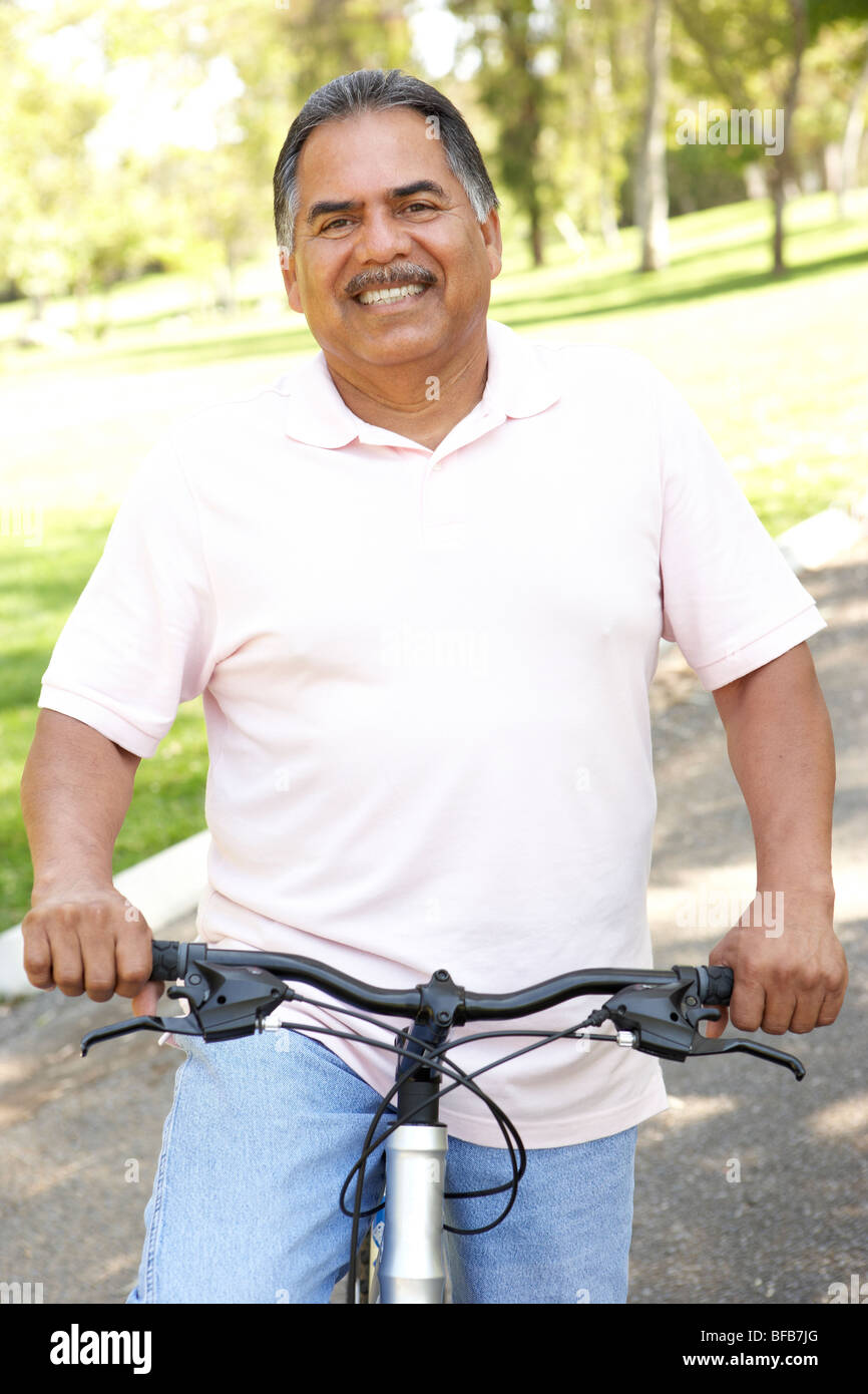 Senior Man Riding Bike In Park Stock Photo - Alamy
