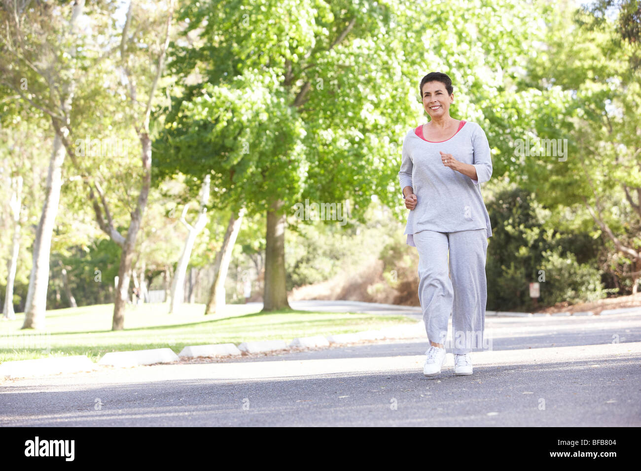 Older hispanic woman jogging hi-res stock photography and images - Alamy