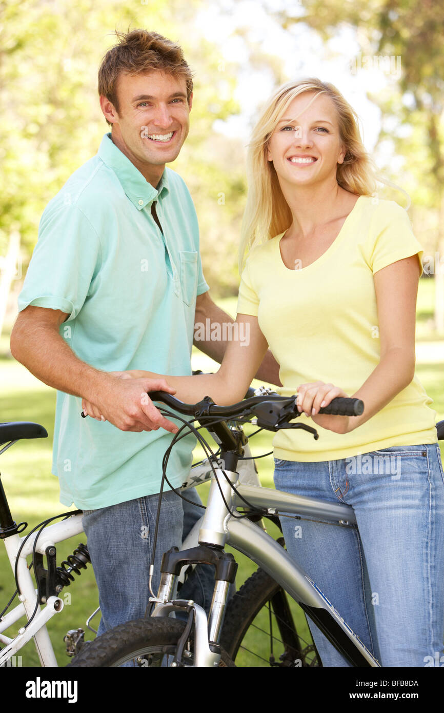 Young Couple On Cycle Ride in Park Stock Photo - Alamy