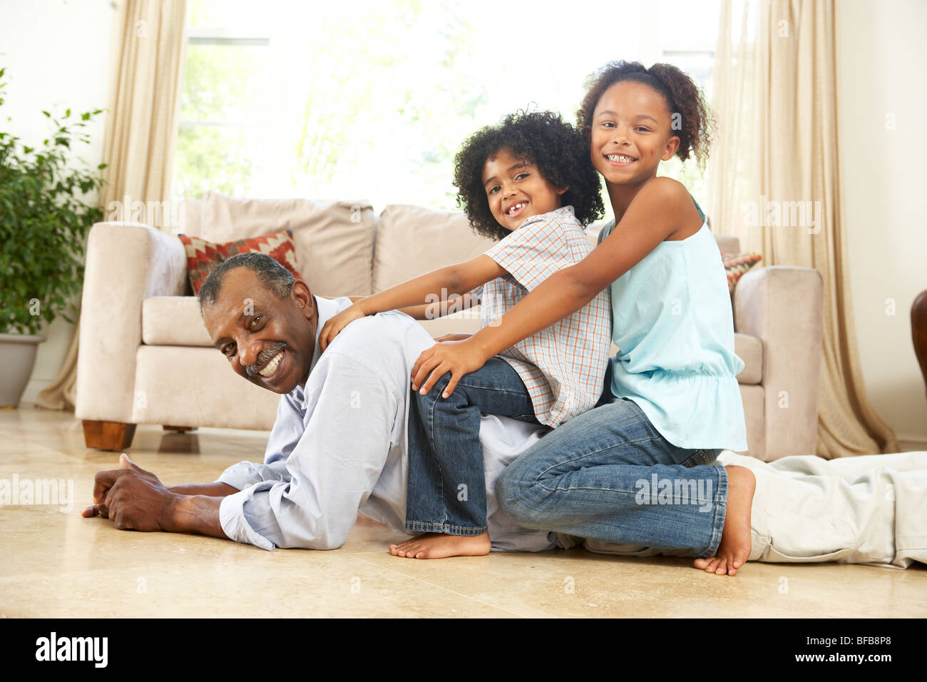 Grandfather Playing With Grandchildren At Home Stock Photo - Alamy