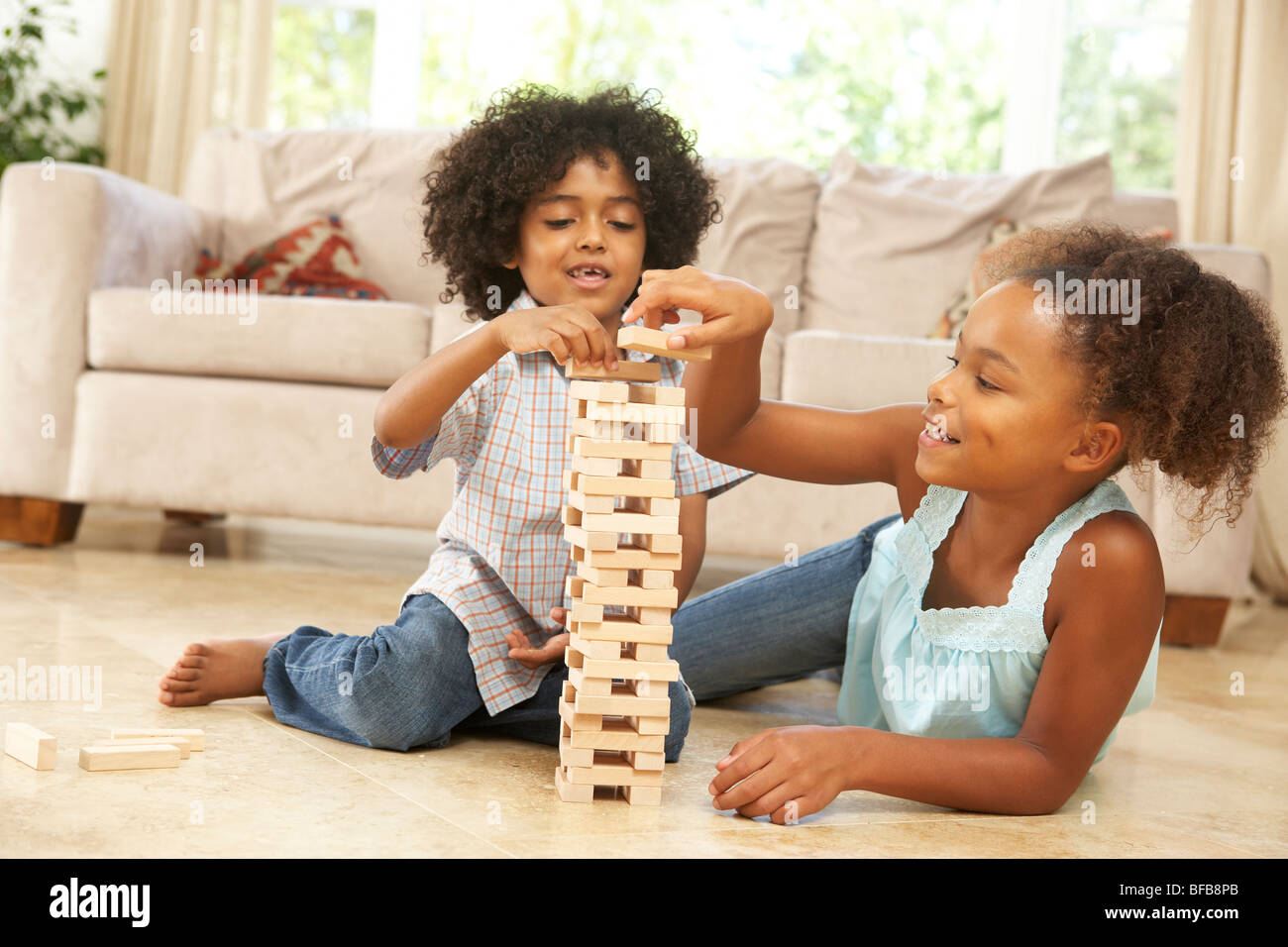 Brother And Sister Playing Game At Home Stock Photo - Alamy