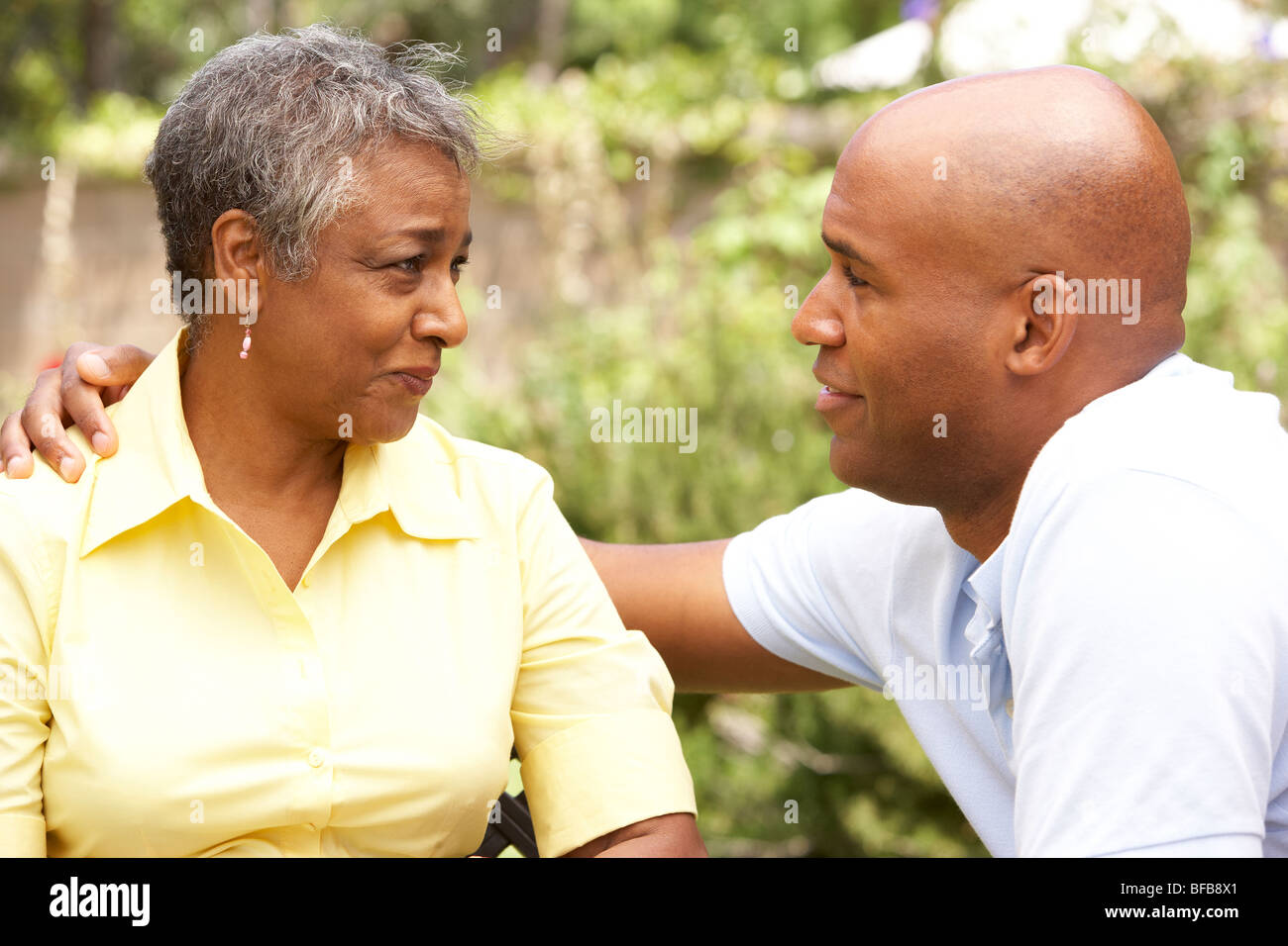 Senior Woman Being Consoled By Adult Son Stock Photo - Alamy
